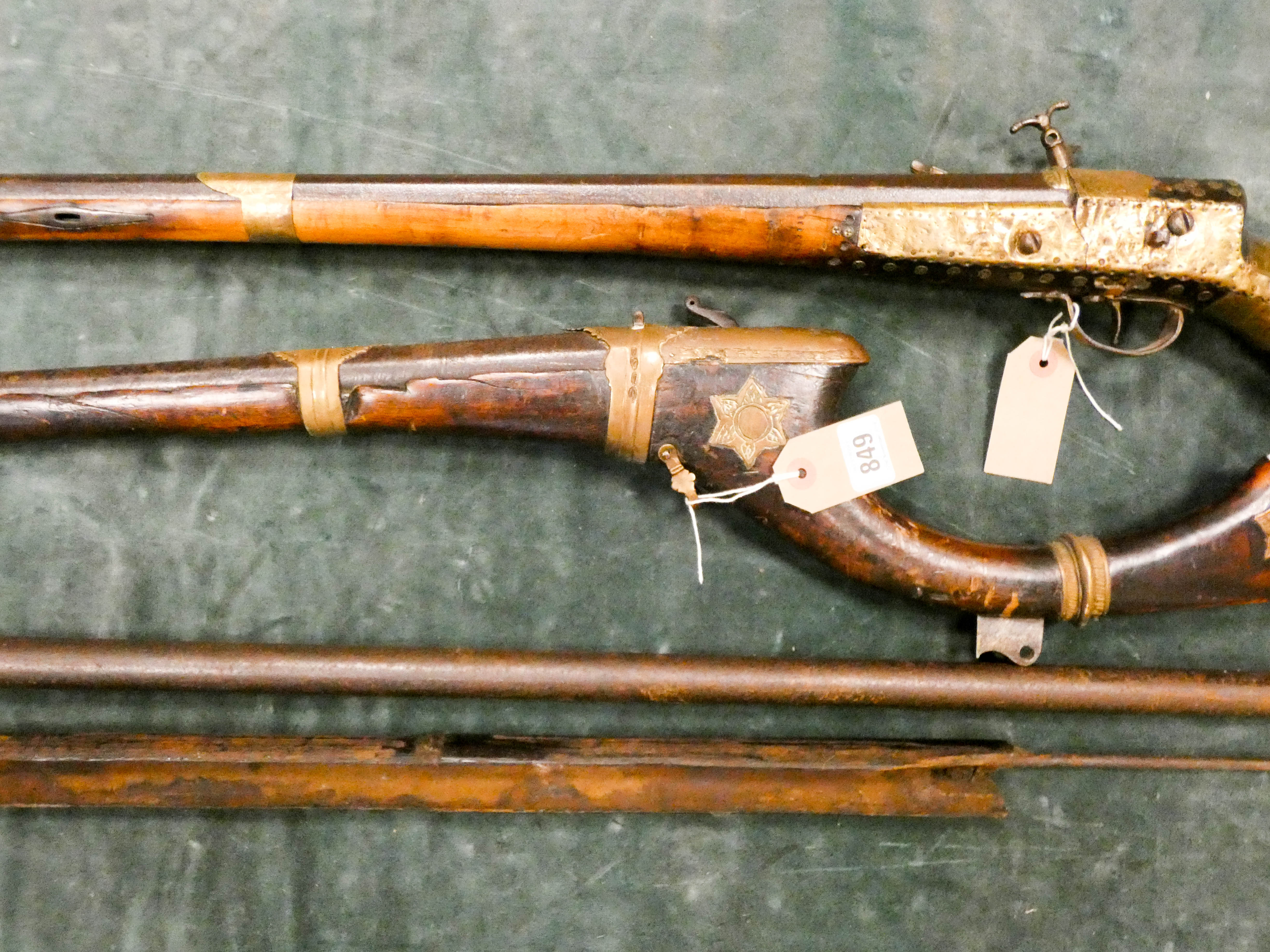 Two old Indian guns, the first a flint lock with octagonal barrel, the ...