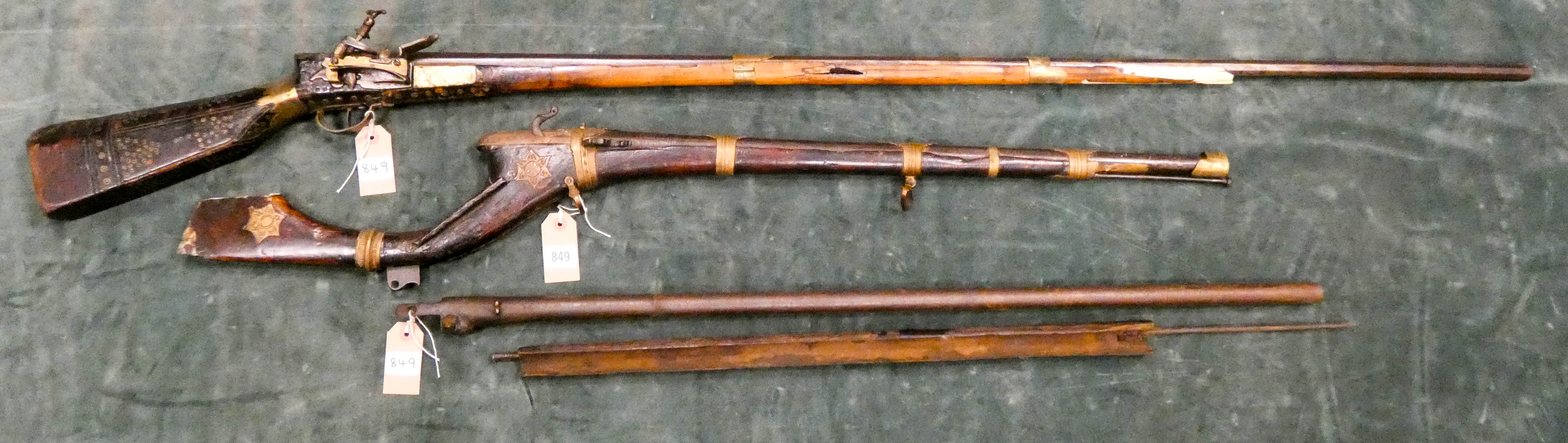 Two old Indian guns, the first a flint lock with octagonal barrel, the ...