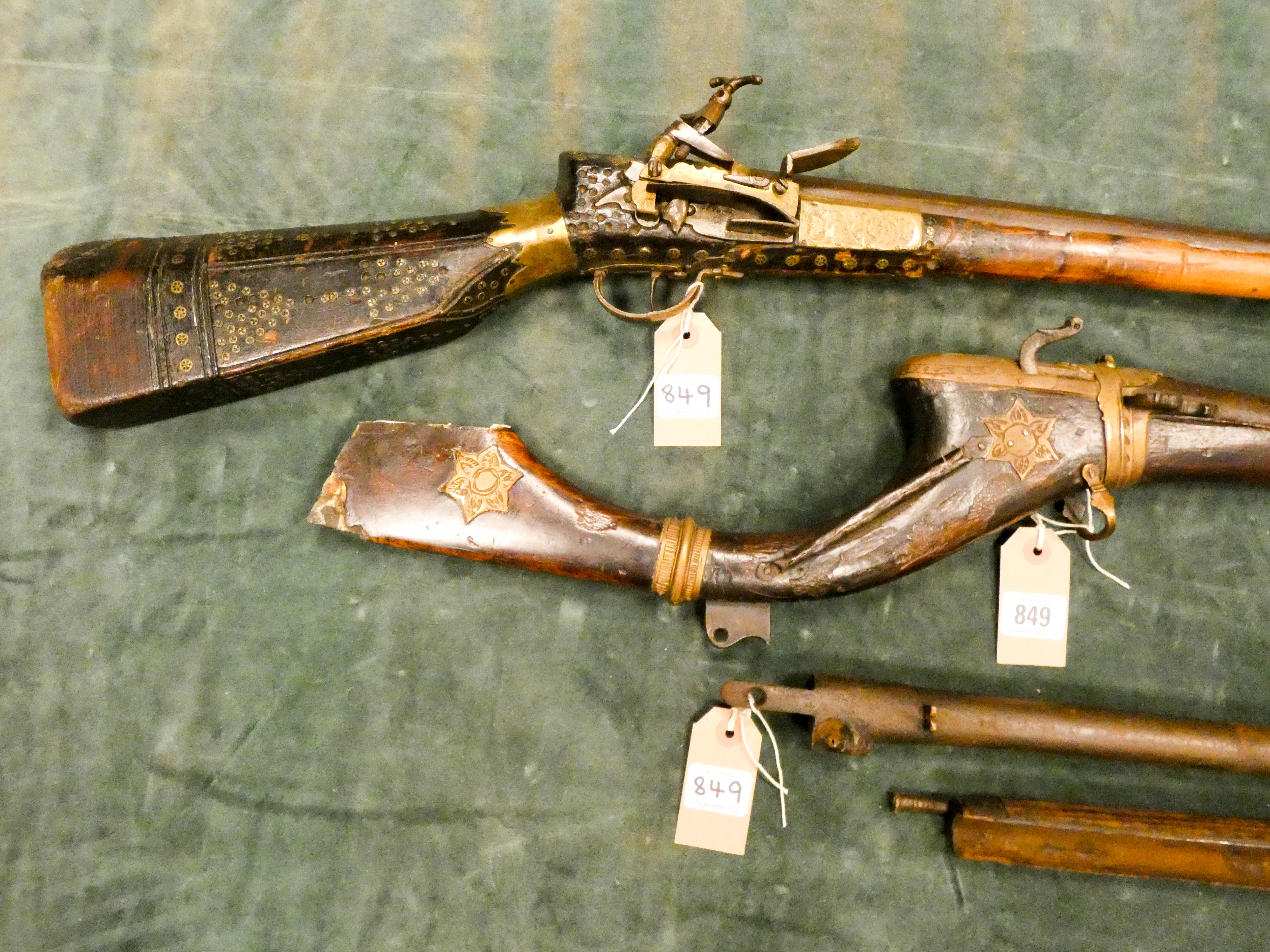 Two old Indian guns, the first a flint lock with octagonal barrel, the ...