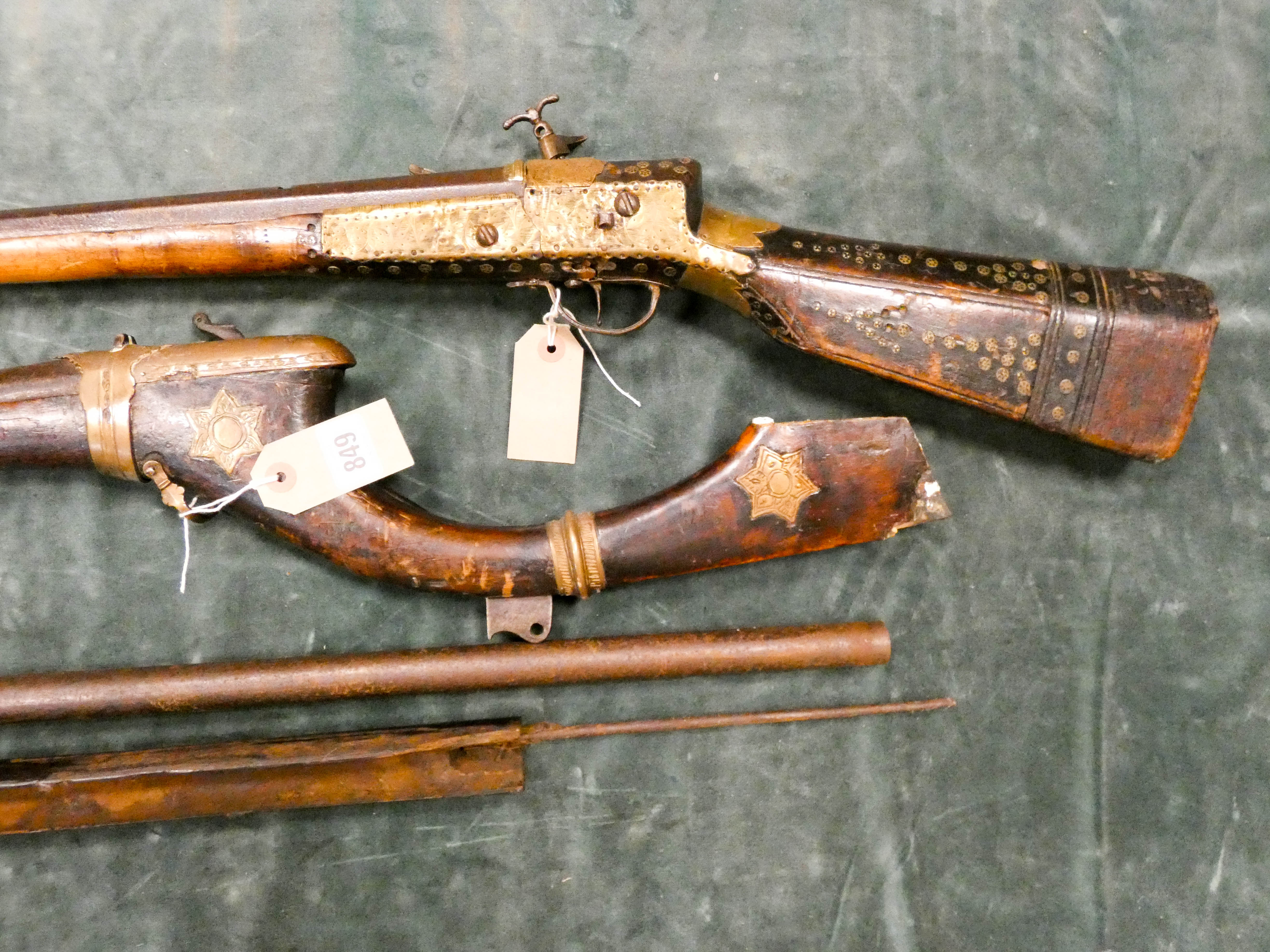 Two old Indian guns, the first a flint lock with octagonal barrel, the ...