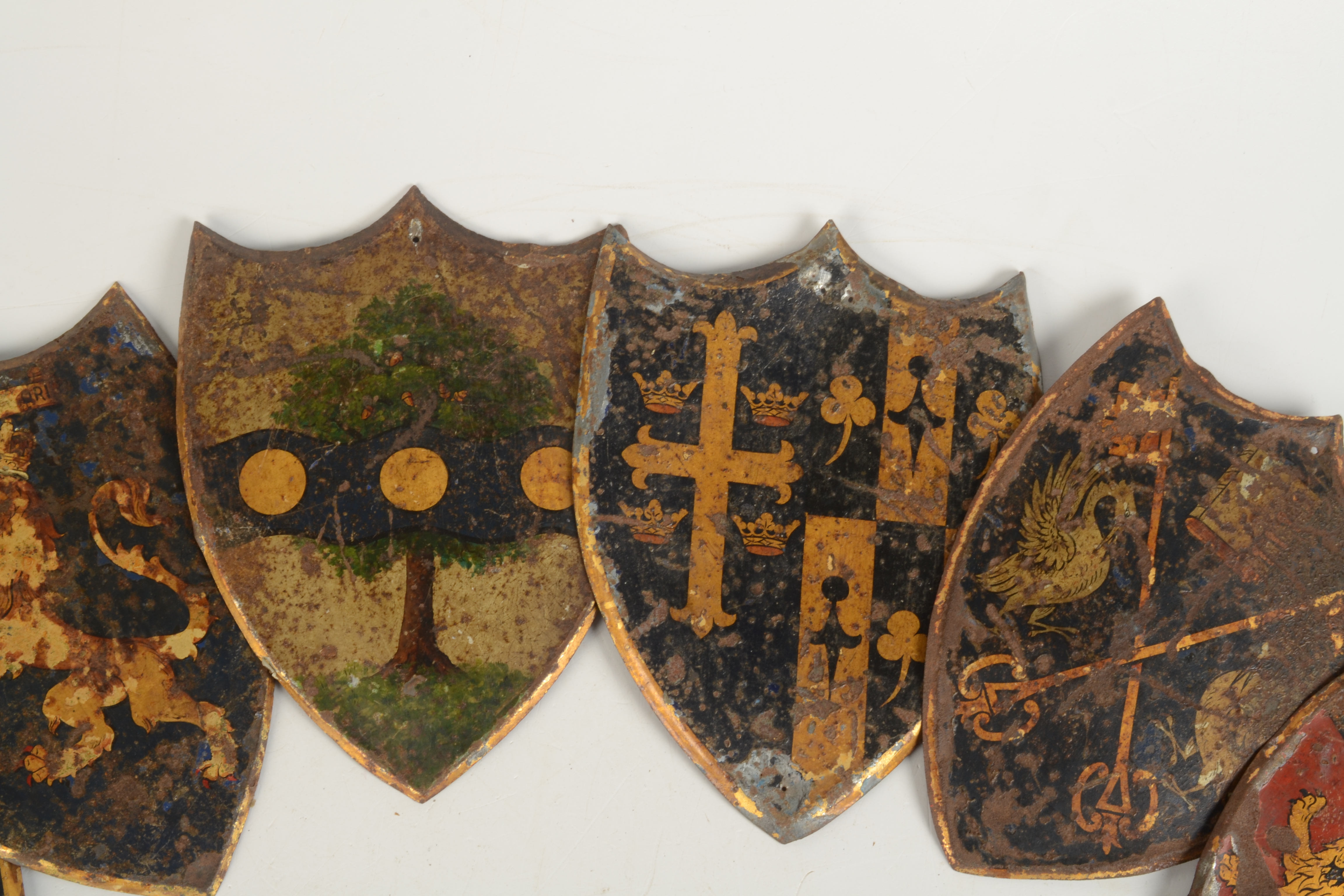 Six painted metal armorial shields with gilt border decoration, 22.5 x ...