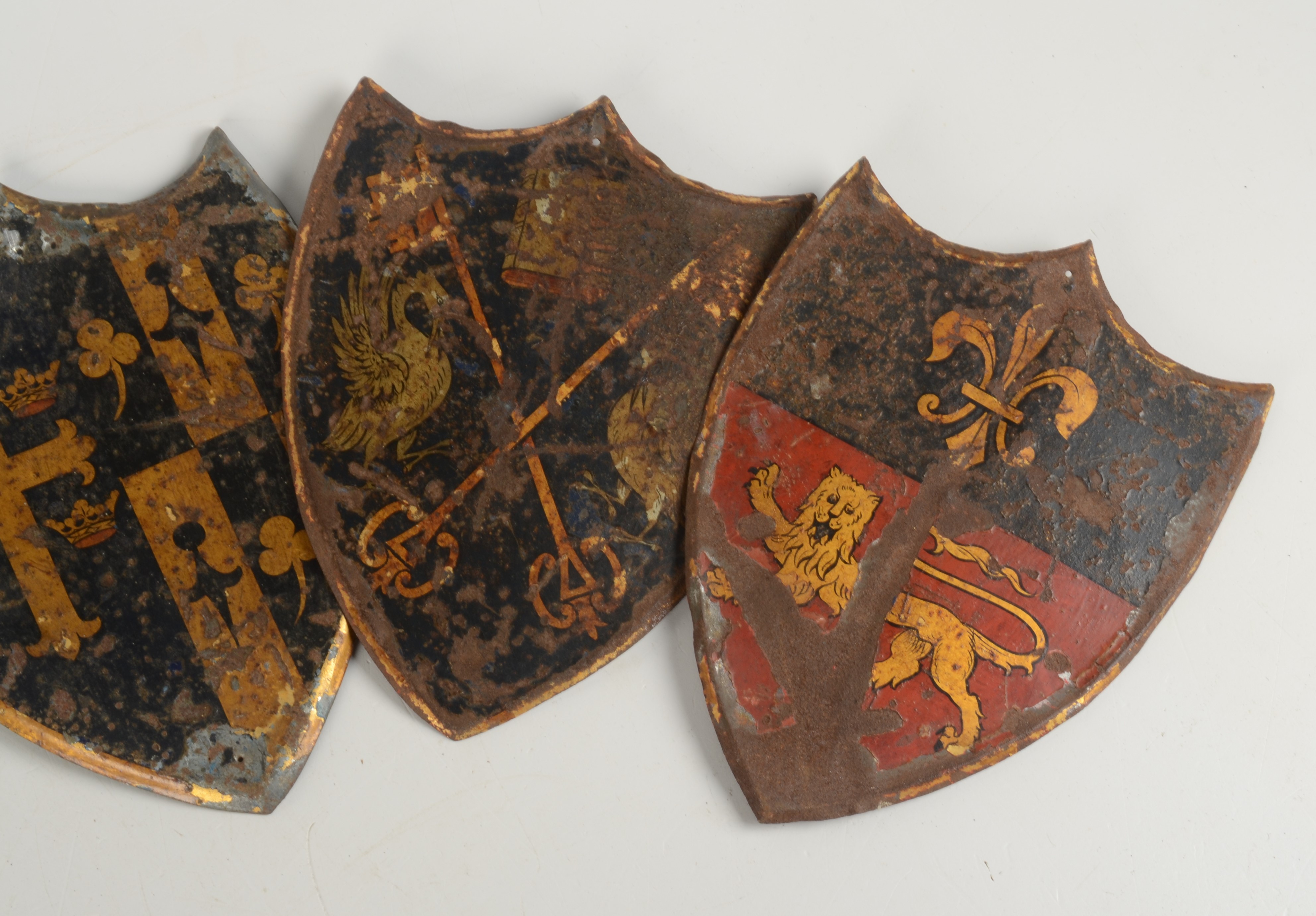 Six painted metal armorial shields with gilt border decoration, 22.5 x ...