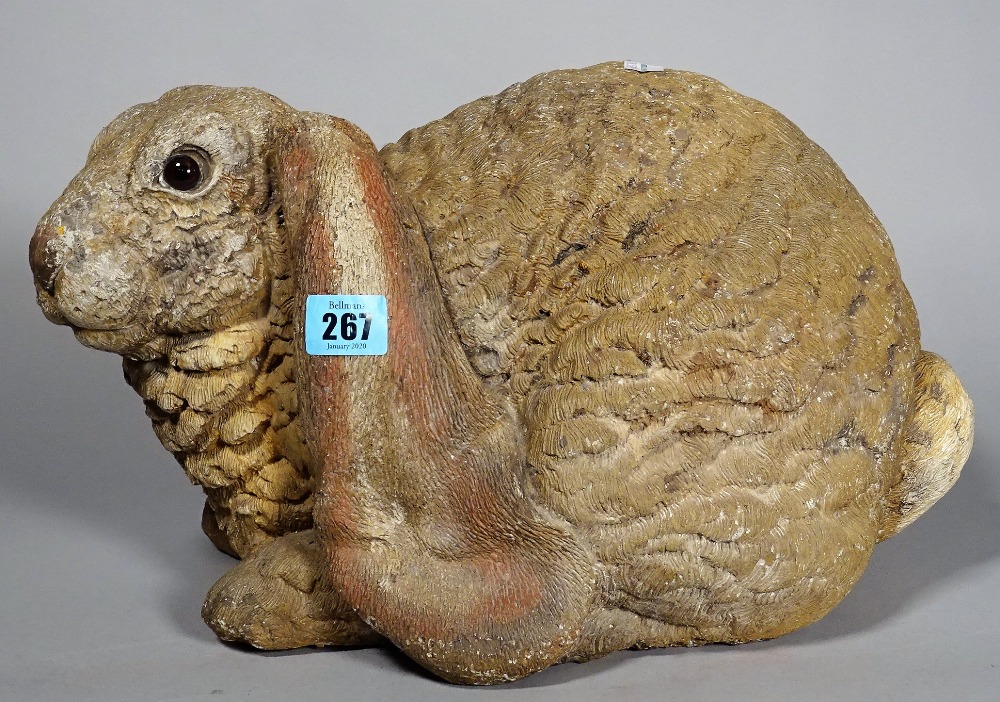 A 20th century painted stone rabbit, 38cm wide x 24cm high.