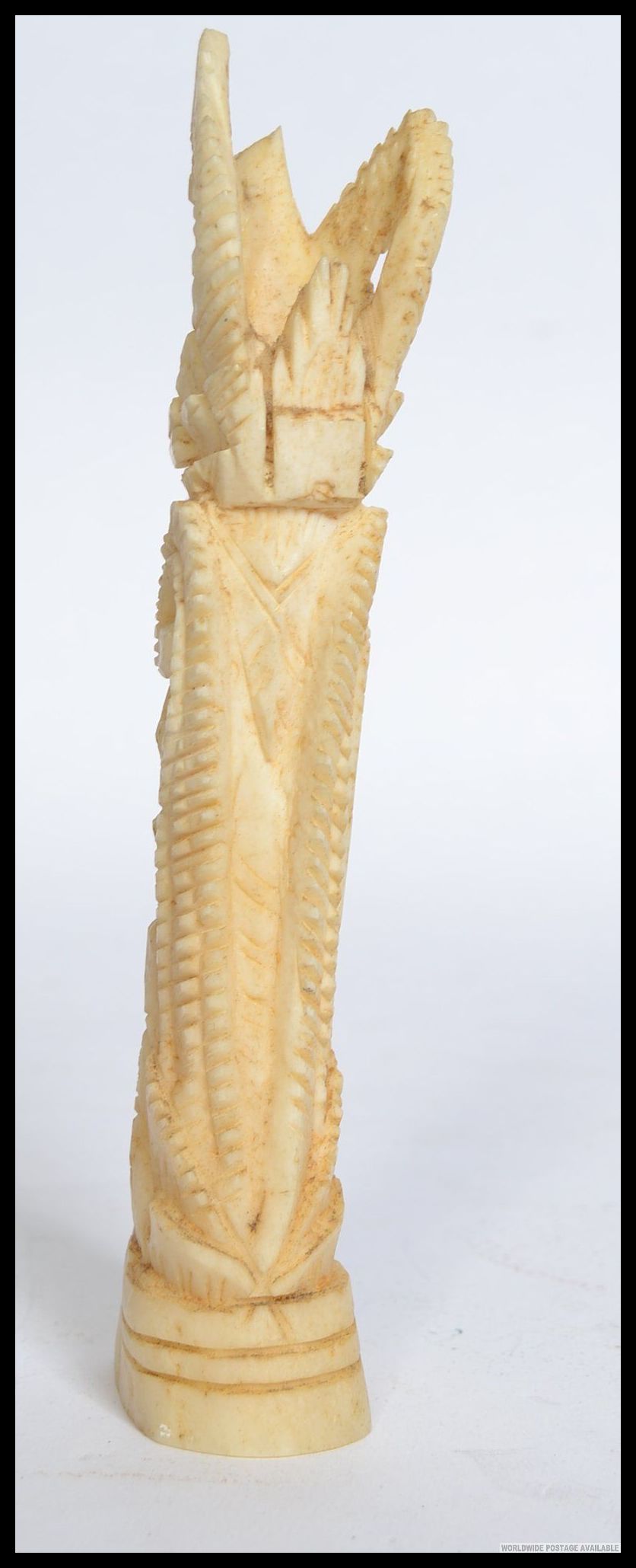 A 20th century carved bone totem statue.