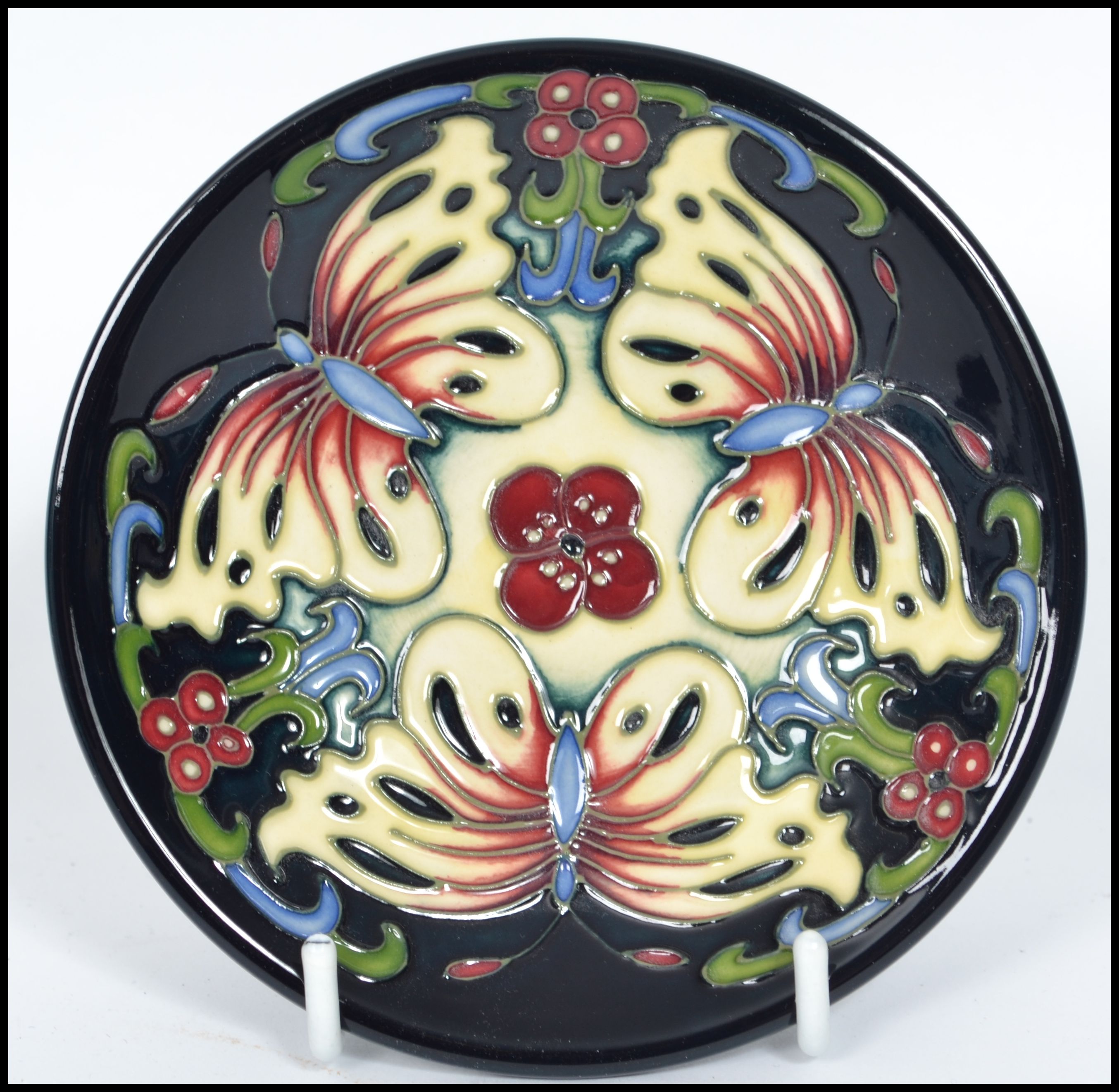 A Moorcroft ceramic tube lined coaster pin dish decorated in the Burley ...