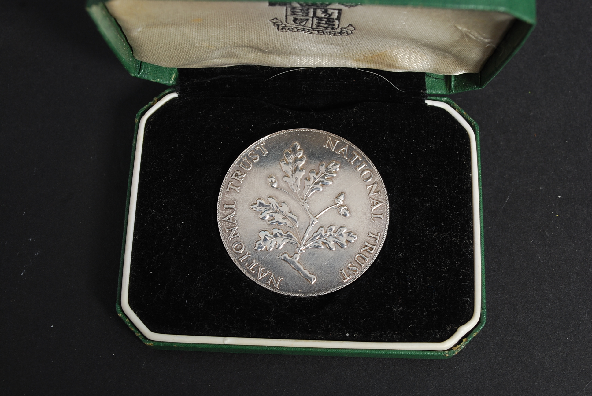 A silver hallmarked National Trust Commemorative coin, complete with ...