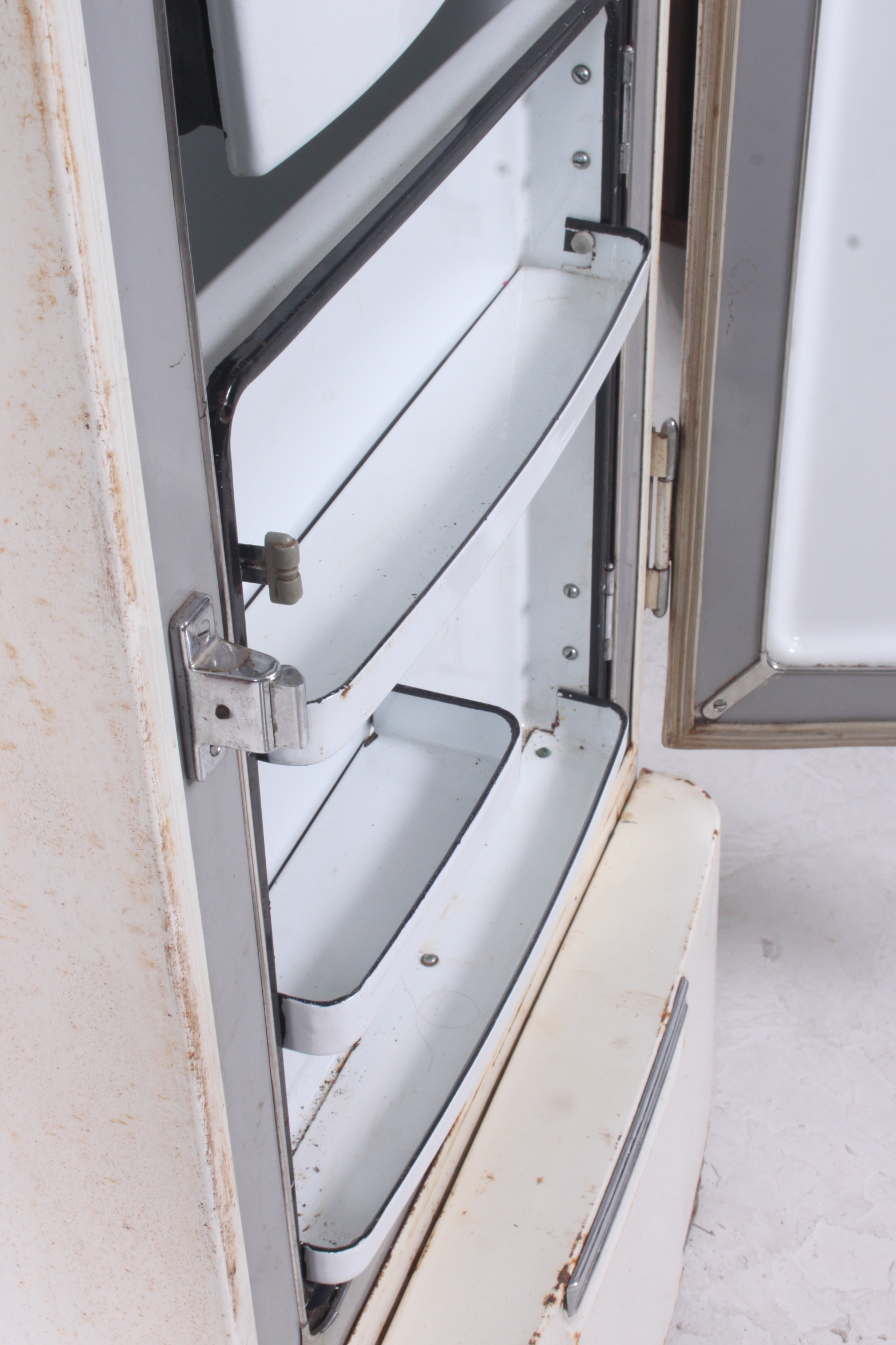 A vintage 1950's Prestcold fridge having the original enamel painted ...