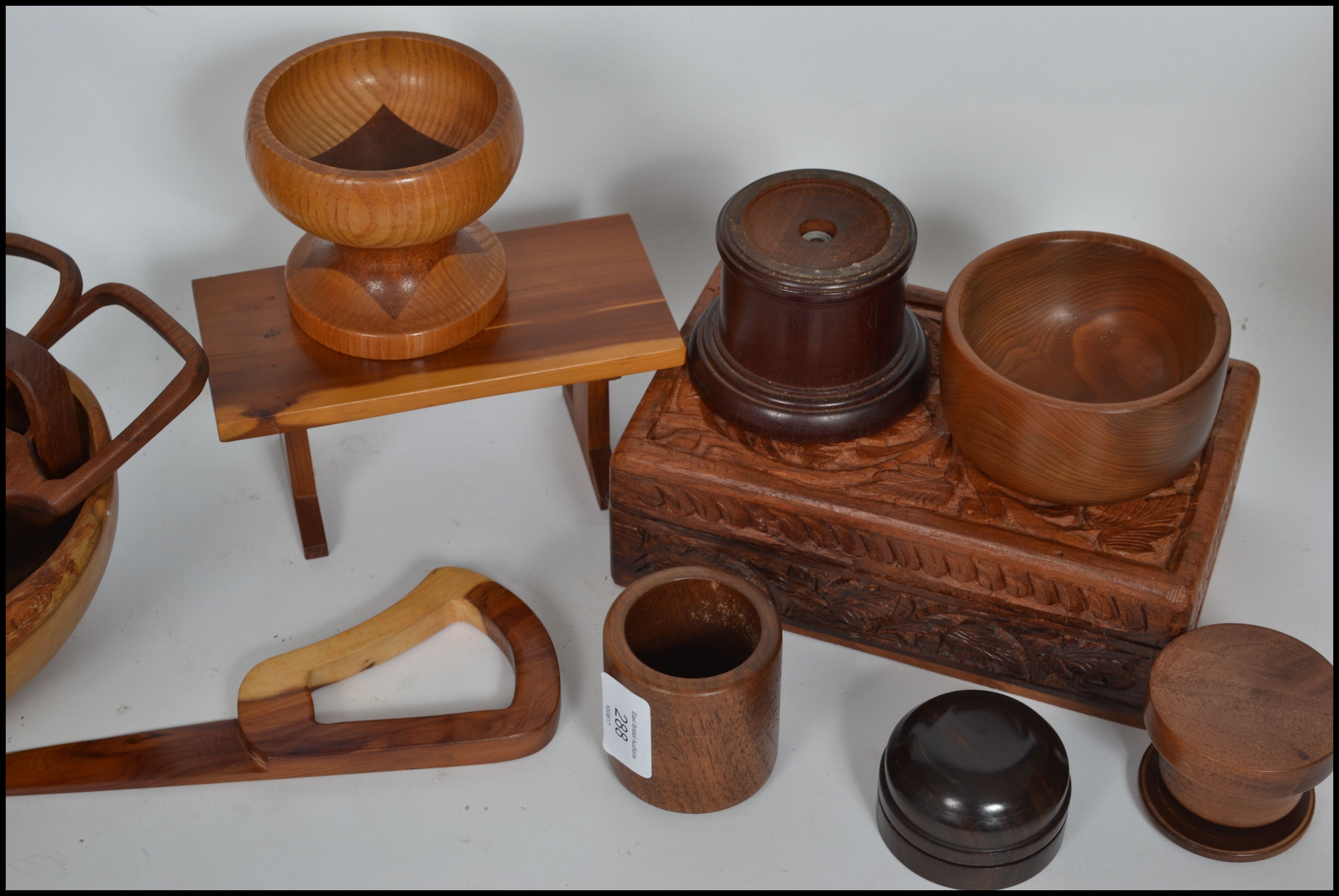 A collection of wooden treenware items to include beakers, pots, lidded ...
