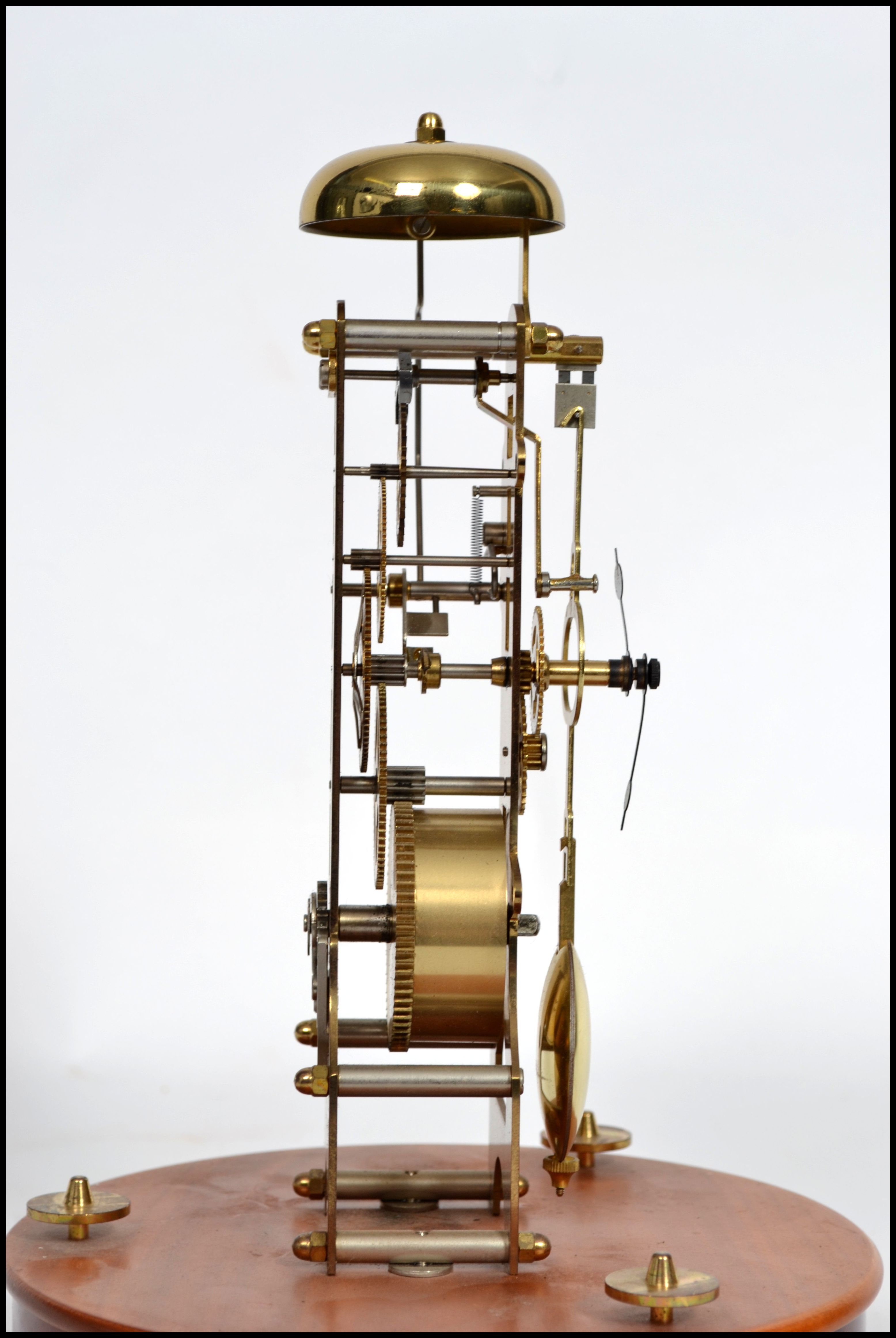 A Franz Hermle skeleton clock 791-081 having a pointed conical glass ...