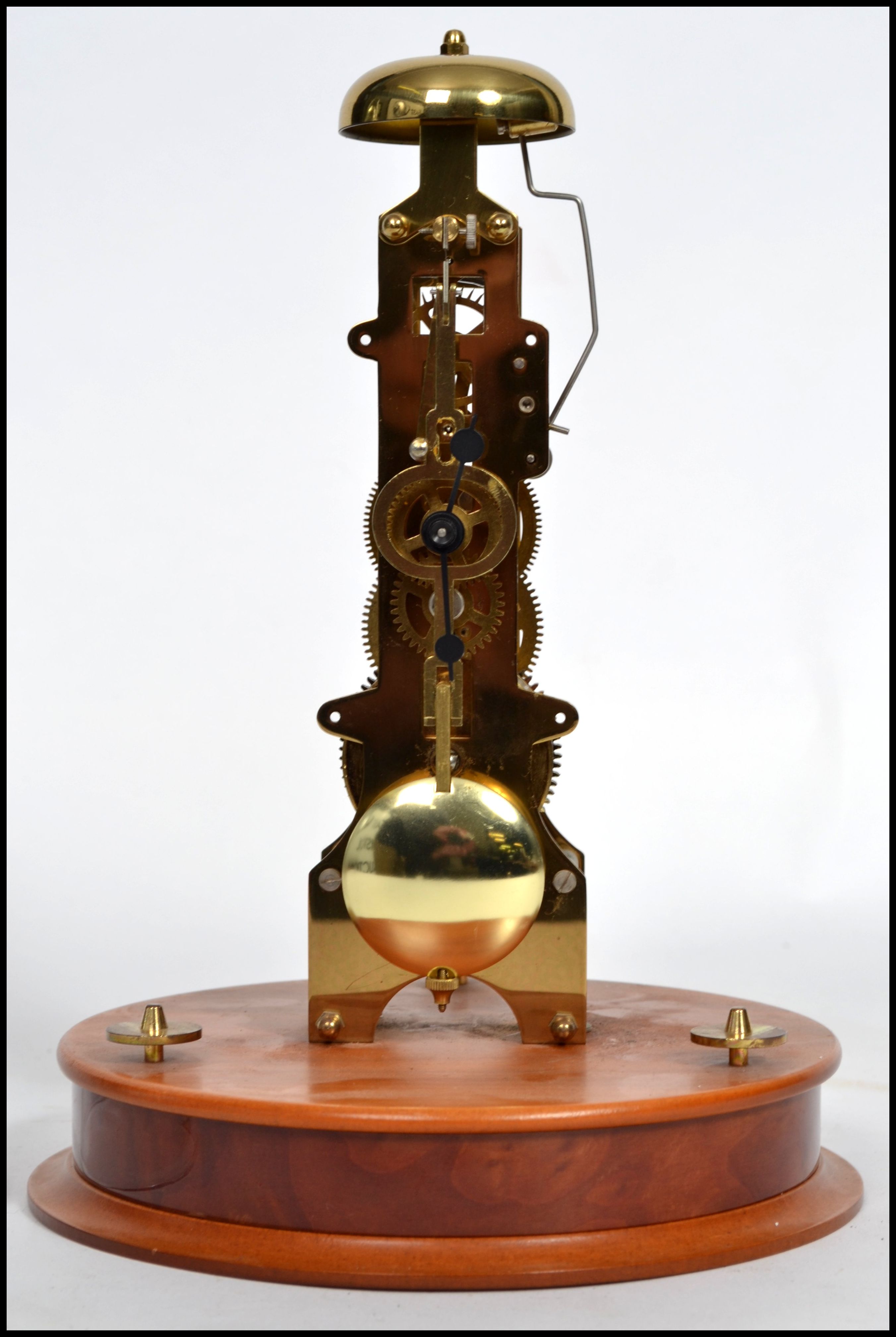 A Franz Hermle skeleton clock 791-081 having a pointed conical glass ...